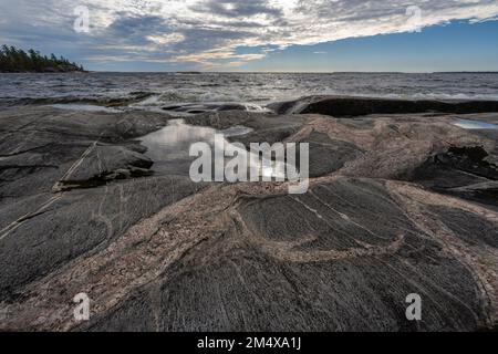 Lake Superior shoreline granite outcrops with igneous dykes at ...