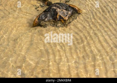 Shoreline rocks, sand ripples and shallow water, Lake Superior ...