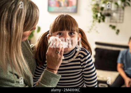 Front view boy wiping face painting off with a tissue Stock Photo - Alamy