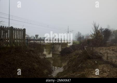 Railroad track next to a stream of water on a foggy day in autumn Stock ...