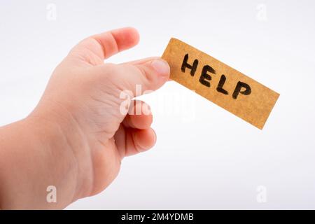 Help word on a piece paper in hand Stock Photo - Alamy