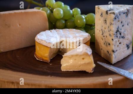 Cheese plate and wine including chardonnay, gourmet crackers, a washed ...