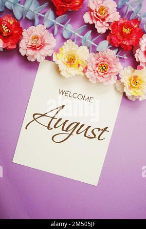 Hello August typography text decorate with flower on pink background ...