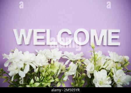 Welcome alphabet letters decorate with Flowers on purple background Stock Photo - Alamy