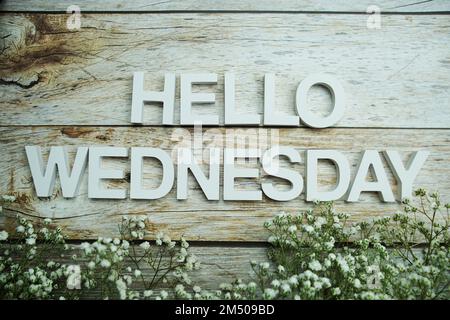 Hello Wednesday alphabet letters with flower frame on purple background ...