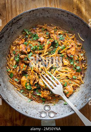 Spanish cuisine seafood pasta with fish and prawns served at plate ...