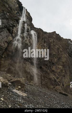 Cirque de Gavarnie with big waterfall and small person at massive high ...
