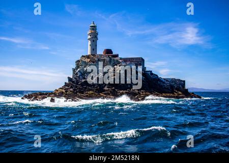 A scenic view of Fastnet lighthouse located on a rocky island in County ...