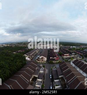 aerial morning suburb sky scene where it is surrounded with oil palm ...