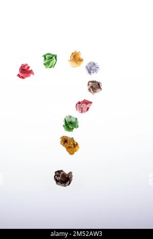 Colorful crumpled paper form a question mark on a white background ...