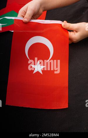 Child hand holding Turkish flag with white star and moon Stock Photo ...