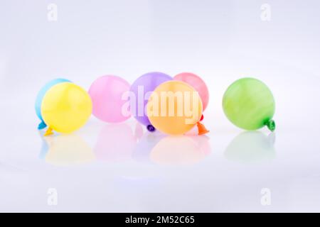 small balloons of various color on a white background Stock Photo - Alamy