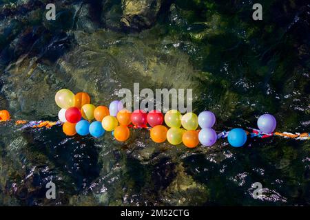 Balloons in shooting range as targets on water Stock Photo - Alamy