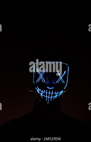 A Purple and blue Halloween led mask with black background Stock Photo ...
