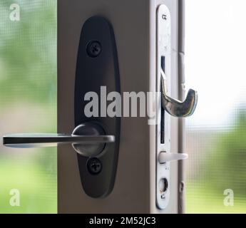 Handle, locking hardware, and jam to a sliding glass and screen door ...