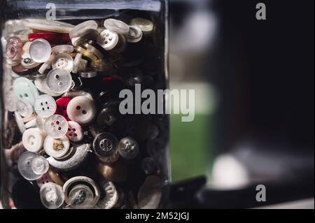 assortment random colored loose buttons in a glass jar Stock Photo - Alamy