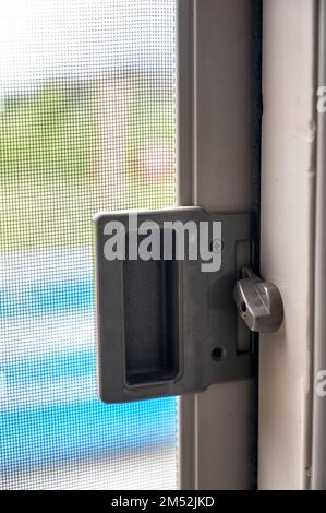 Interior sliding screen door hardware and flip latch Stock Photo - Alamy