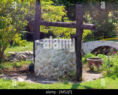 old well made of bricks and wooden pole Stock Photo - Alamy