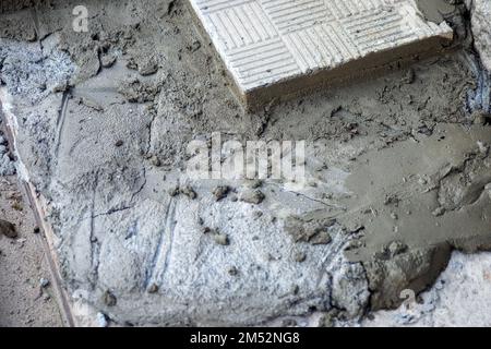 Close-up of liquid cement. Paving tile. Construction background. Pile ...