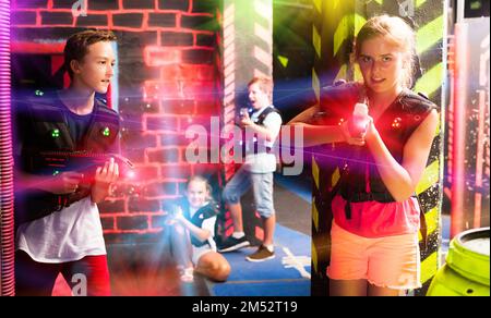 Girls and boys playing laser tag Stock Photo - Alamy