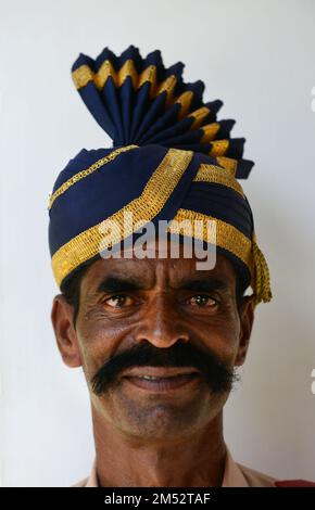Portrait of a Tamil man wearing a uniform and a colorful turban ...