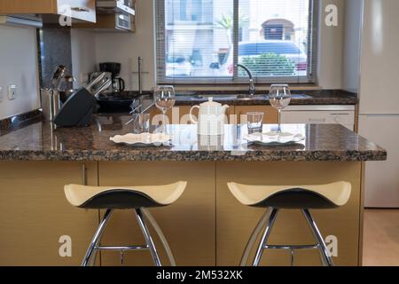Kitchen furniture with stools to sit down to eat and various kitchen ...