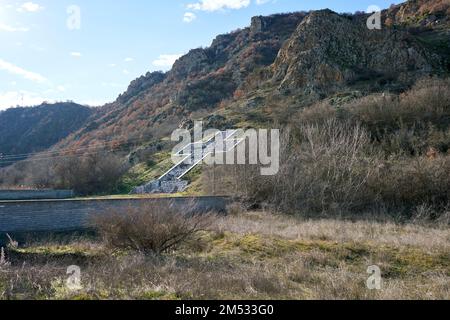 A brick cross on the slope of a rocky hill on a sunny morning Stock ...