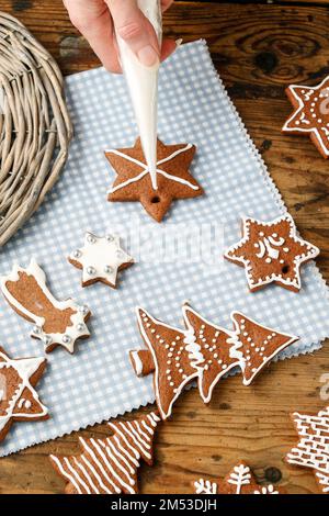 Decorating gingerbread cookies for christmas. Steps of making biscuits ...