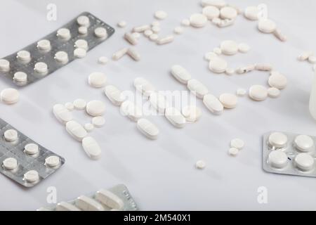 Word PILLS lined with tablets Stock Photo - Alamy