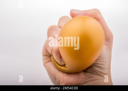 Squeezing yellow balloon with hand on a white background Stock Photo ...