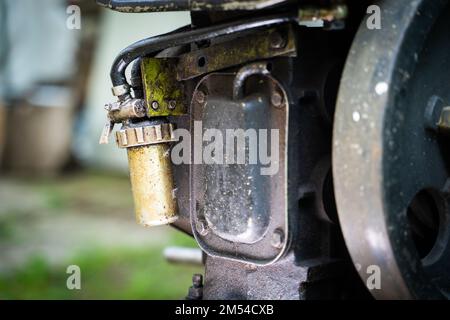 Chinese fuel filter on a walk-behind tractor close-up on a blurred ...