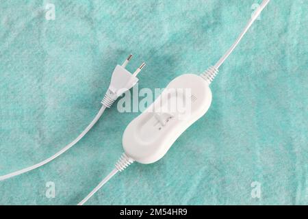 Electric heating pad with controller and plug on white background ...