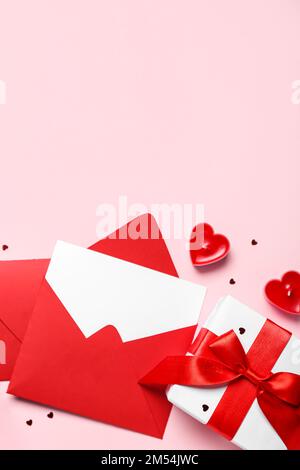 Envelopes with gift and candles on pink background. Valentine's Day ...