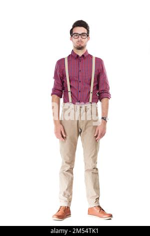 Serious handsome man posing and looking at camera isolated over yellow ...