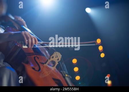 girl playing the cello on stage during a concert Stock Photo - Alamy