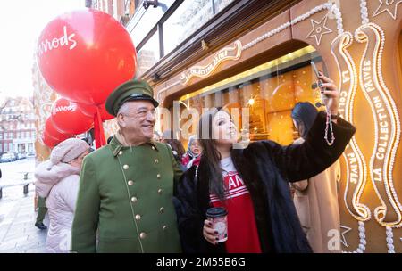 EDITORIAL USE ONLY Michael Pinsker greeting customers queuing outside ...