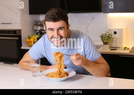 Man eating pasta with bad manners Stock Photo - Alamy
