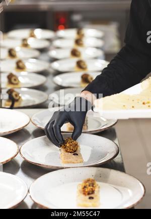 Chef preparing starter dishes on commercial kitchen counter Stock Photo ...