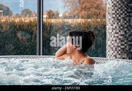 A closeup shot of a female taking a therapy bath in a jacuzzi and ...
