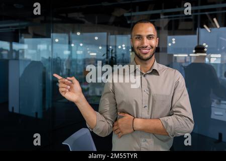 cheerful man pointing with hands near pretty woman with vintage camera ...
