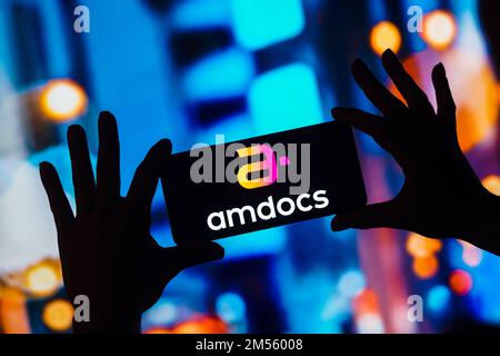 In this photo illustration, the Amdocs Limited company logo is seen displayed on a smartphone ...