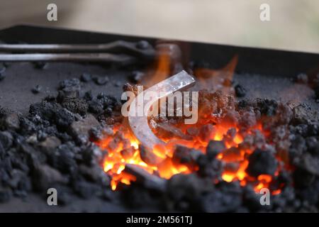 Smithy forging for hardening and heating iron. Blacksmith working at ...