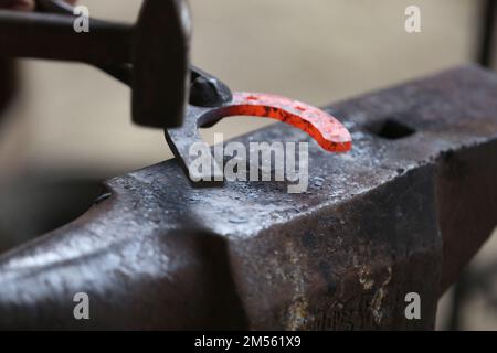Smithy forging for hardening and heating iron. Blacksmith working at ...