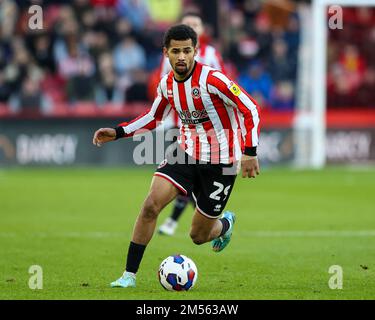 Iliman Ndiaye of Sheffield United runs with the ball with Jason Knight ...