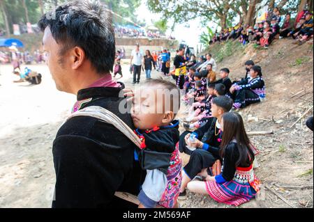 Hmong hill tribe man carries his sleeping baby during the Hmong New ...