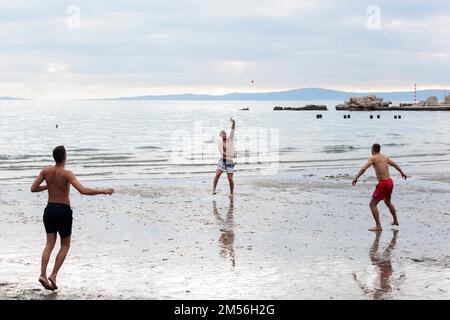 People play a traditional game of picigin during a traditonal Sylvester ...