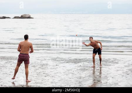 People play a traditional game of picigin during a traditonal Sylvester ...