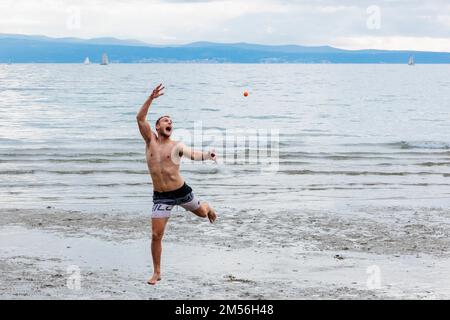 People play a traditional game of picigin during a traditonal Sylvester ...