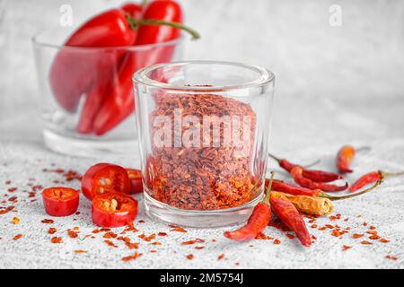 Glass of chipotle chili flakes on light background Stock Photo - Alamy