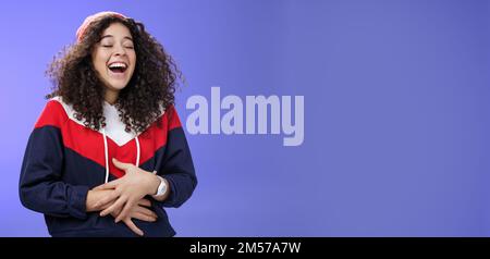 Girl hearing hilarious funny joke, making prank over friend laughing ...